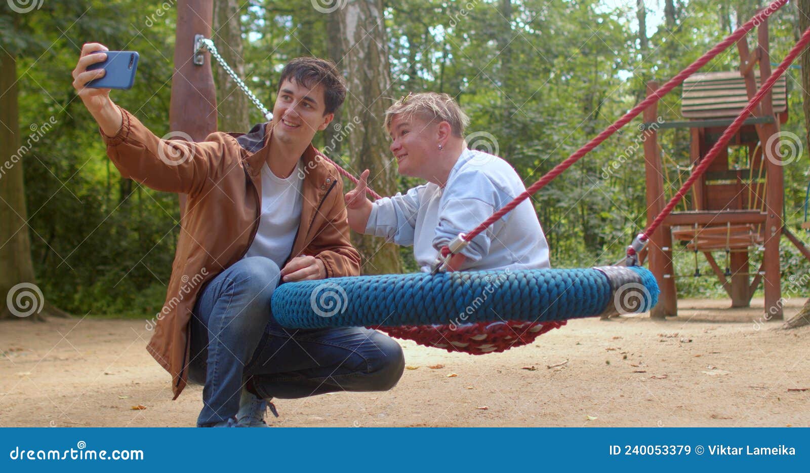 He is Holding a Phone, they are Posing, they are Using the Front Camera ...