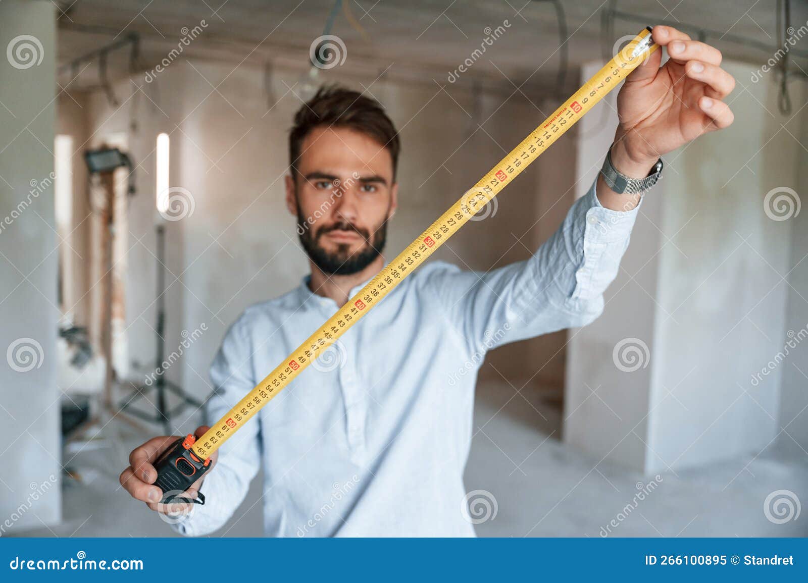 Holding Ruler Measurement Tool. the Man is Making Repairs in the ...