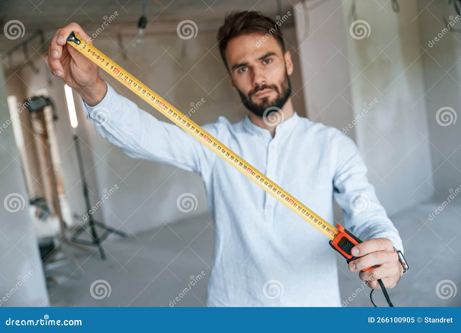 Holding Ruler Measurement Tool. the Man is Making Repairs in the ...
