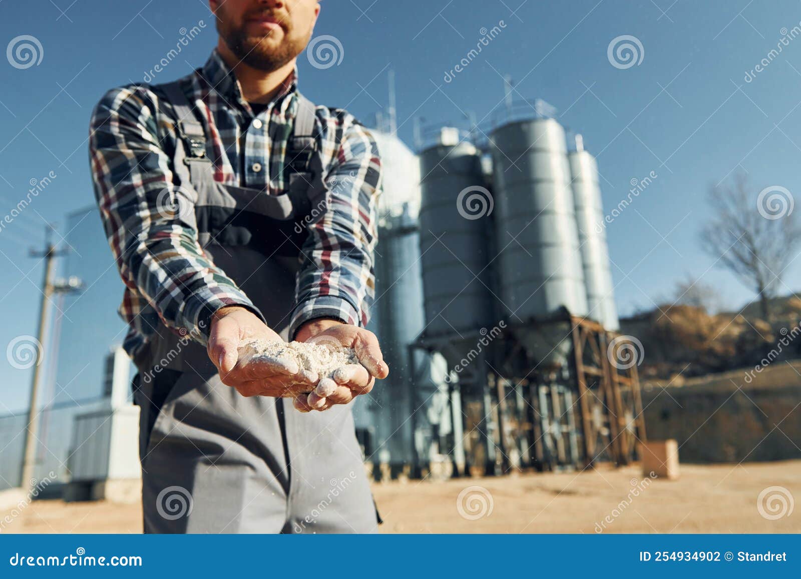 Holding Soil. Construction Worker in Uniform is Outdoors Near the ...