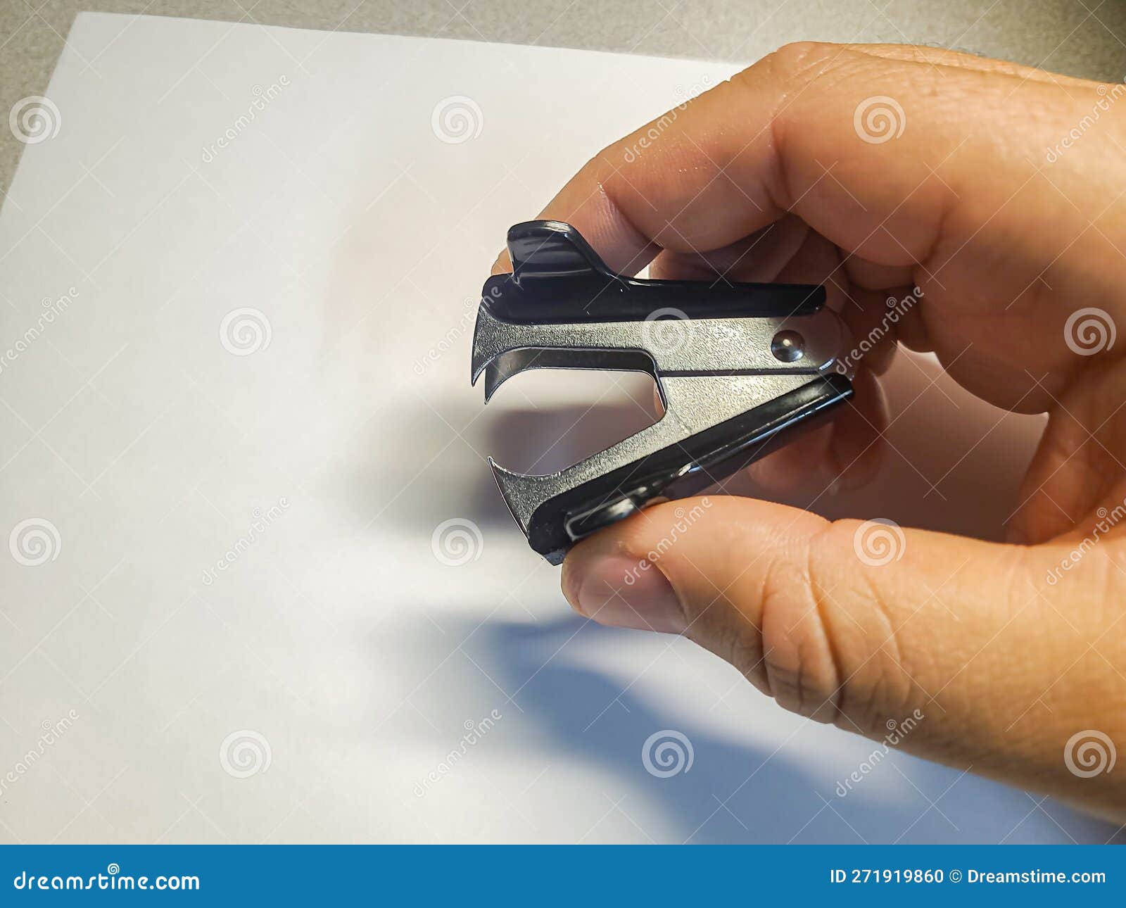 Holding a staple remover stock photo. Image of isolation - 271919860
