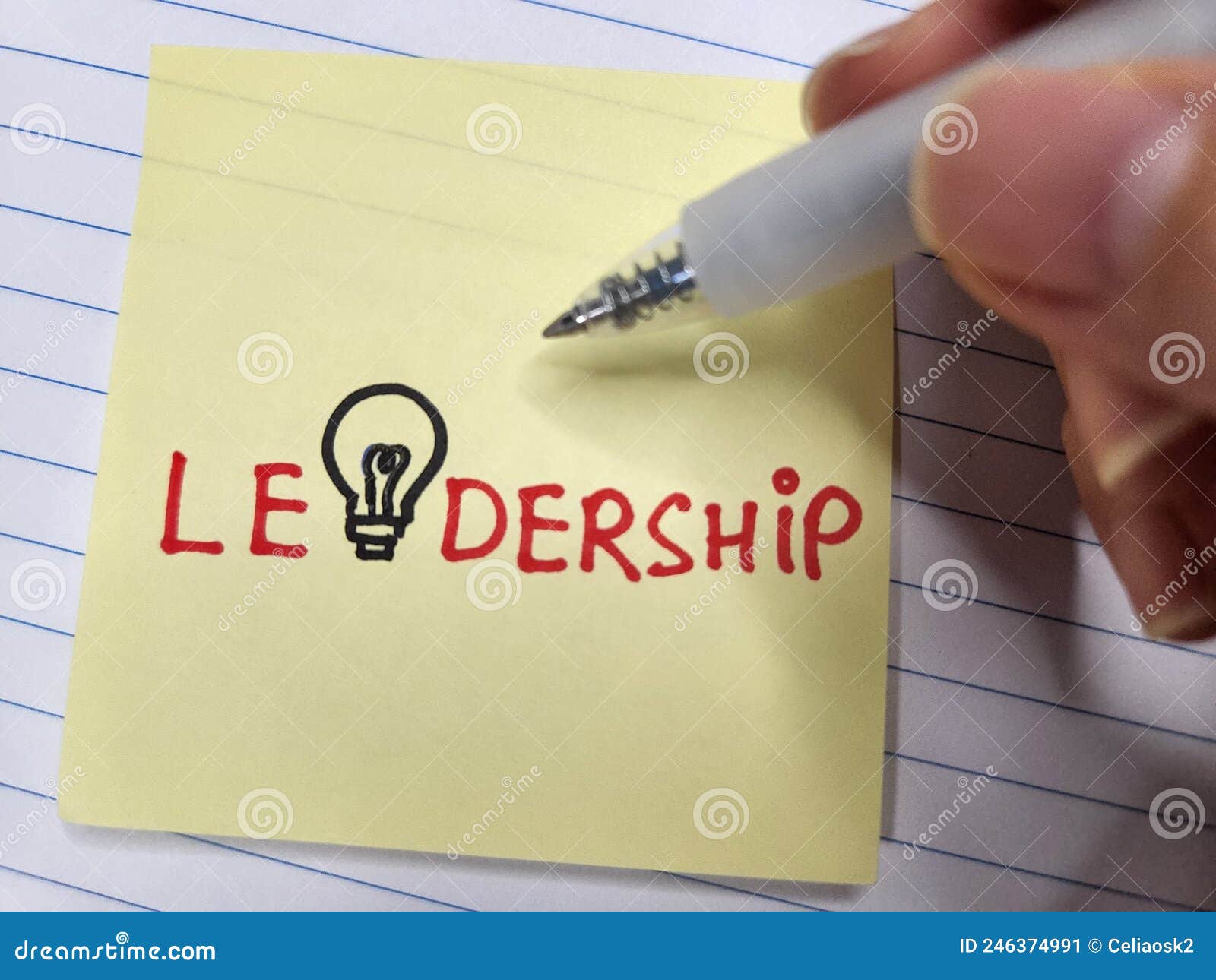 Holding a Pen with a Sticky Note Showing the Word Leadership Stock ...
