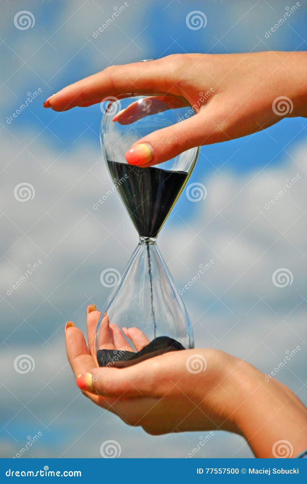 Holding a time stock photo. Image of hourglass, hand - 77557500