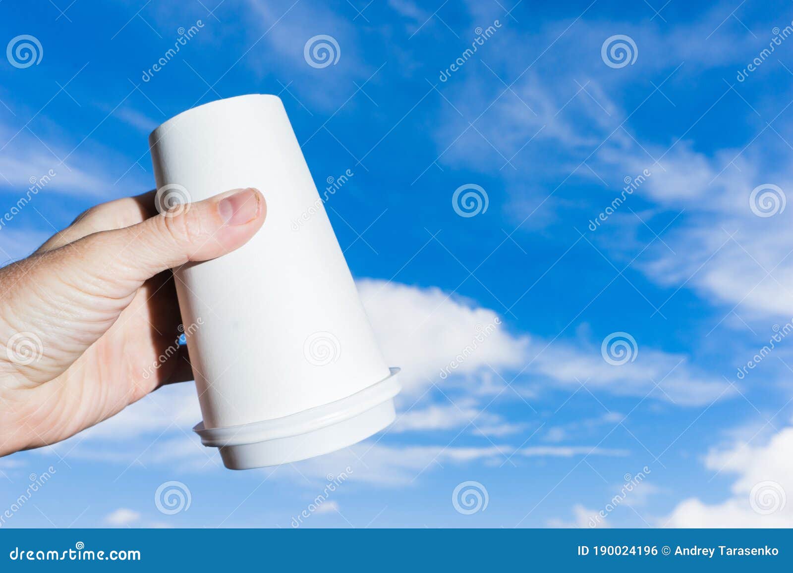 Holding Upside Down a White Paper Cup Against a Blue Sky Stock Photo ...