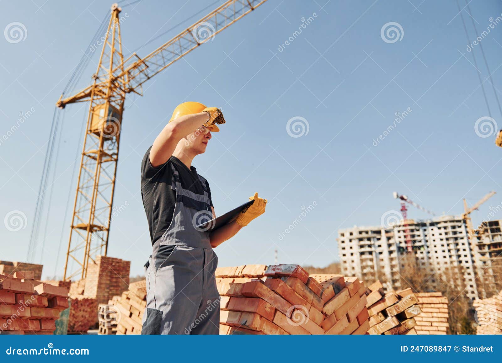 Holds Notepad with Documents. Construction Worker in Uniform and Safety ...