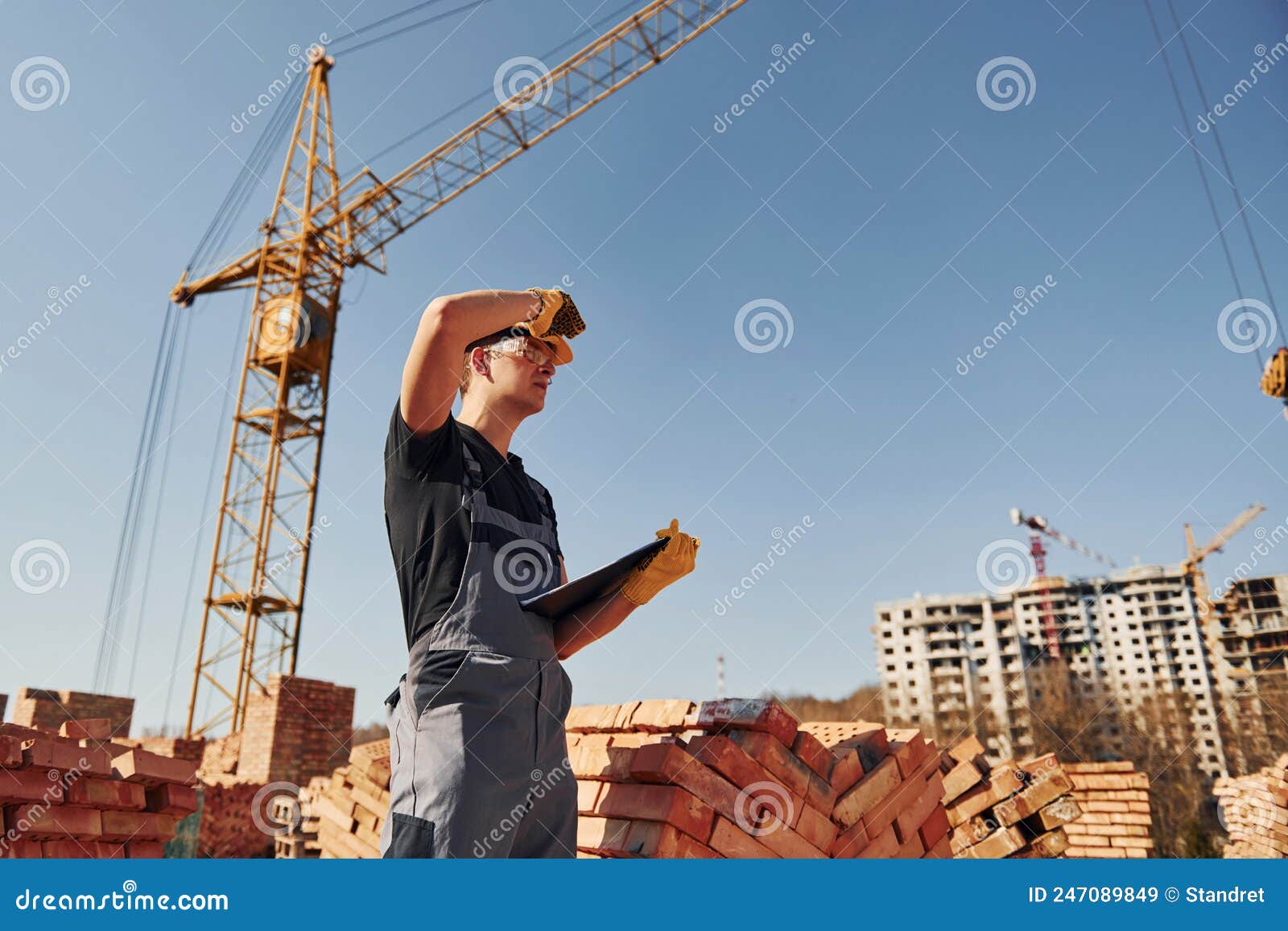 Holds Notepad with Documents. Construction Worker in Uniform and Safety ...