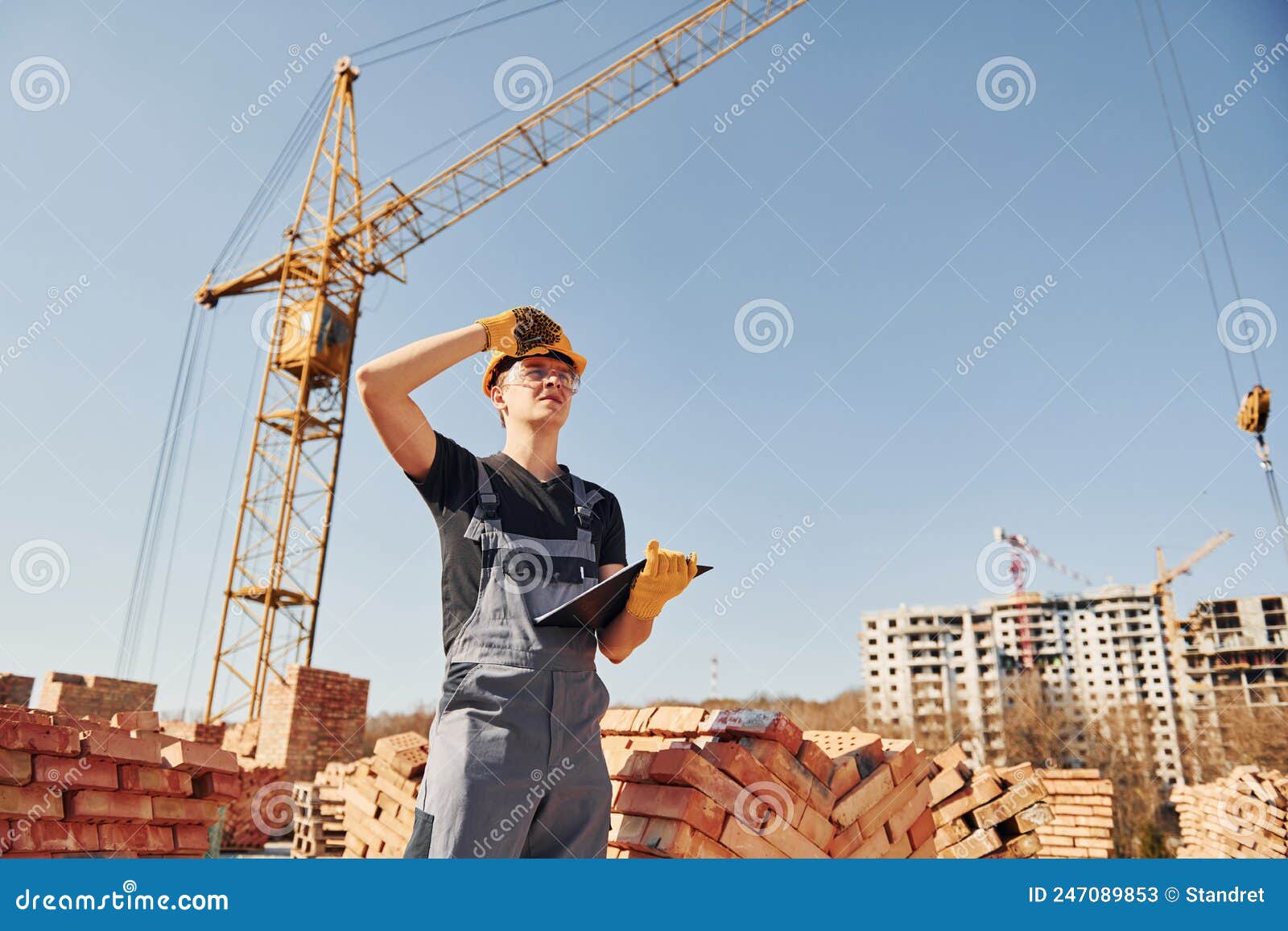 Holds Notepad with Documents. Construction Worker in Uniform and Safety ...