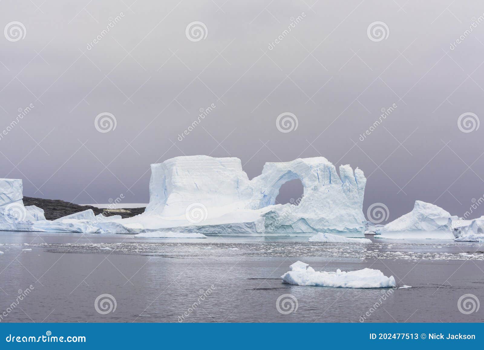 Holed iceberg, Antarctica stock image. Image of colourful - 202477513