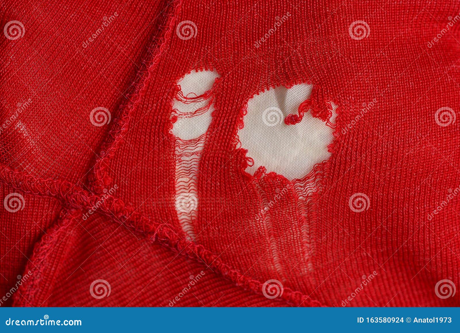Holes on the Red Fabric of Clothing with a Seam Stock Photo - Image of ...
