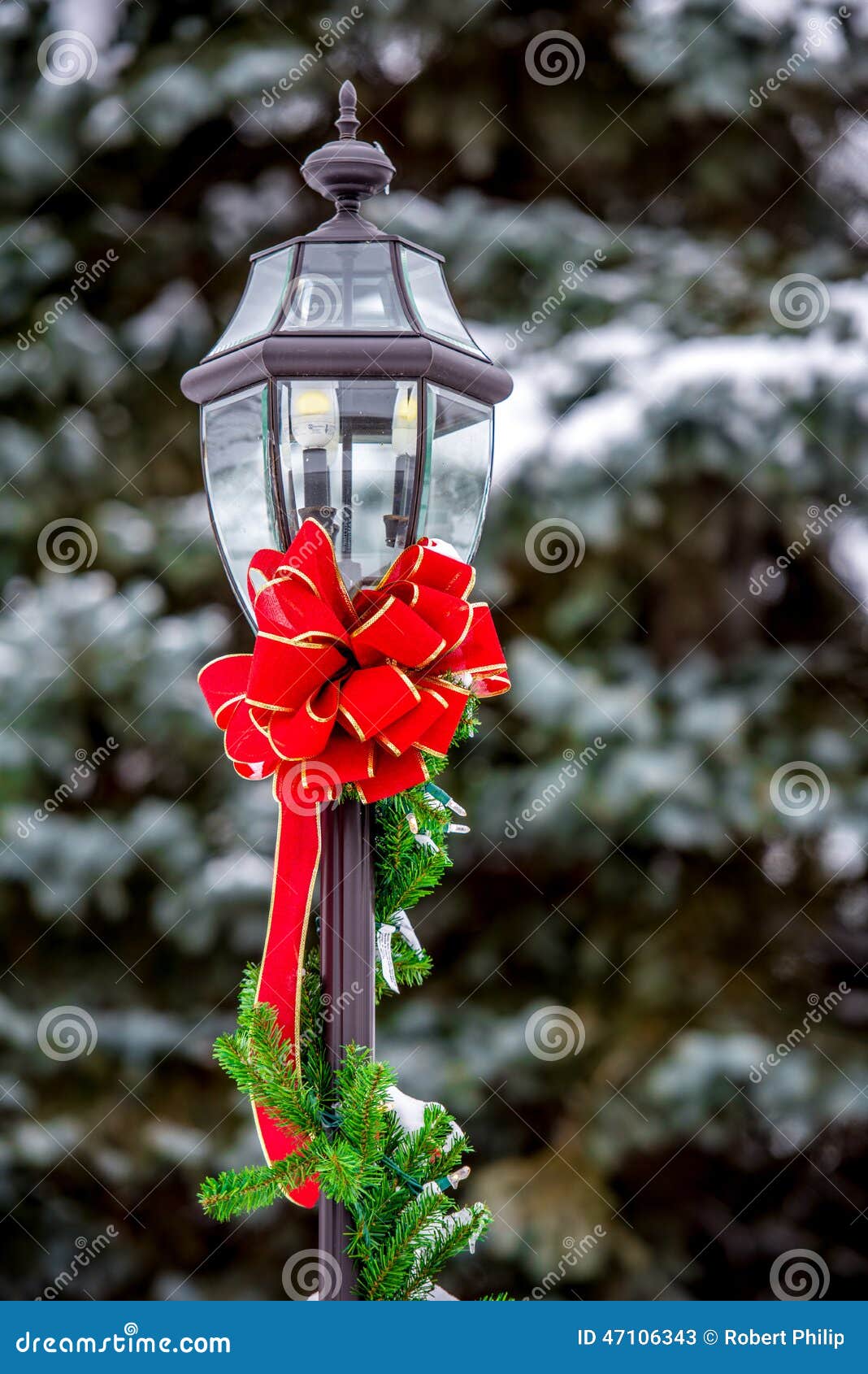 Holiday Red Ribbon on a Yard Light Stock Image - Image of street ...