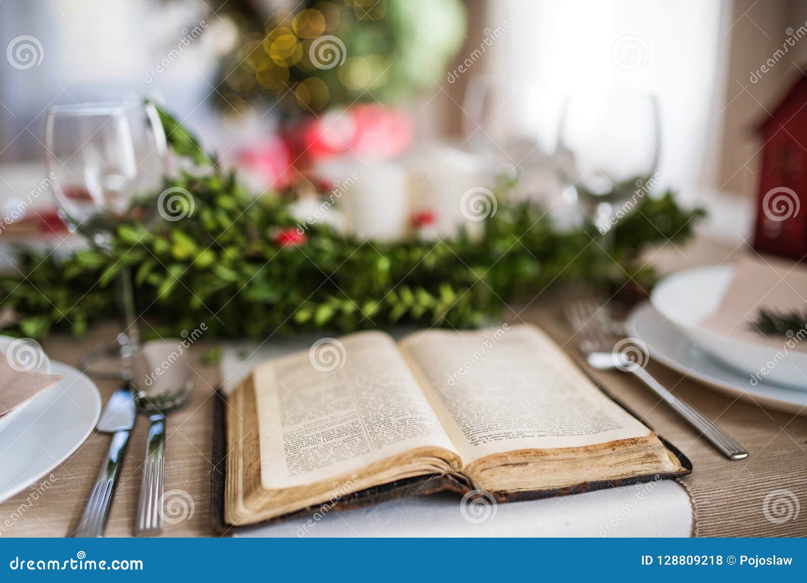 Holy Bible Book on a Table Set for a Dinner at Home at Christmas Time ...