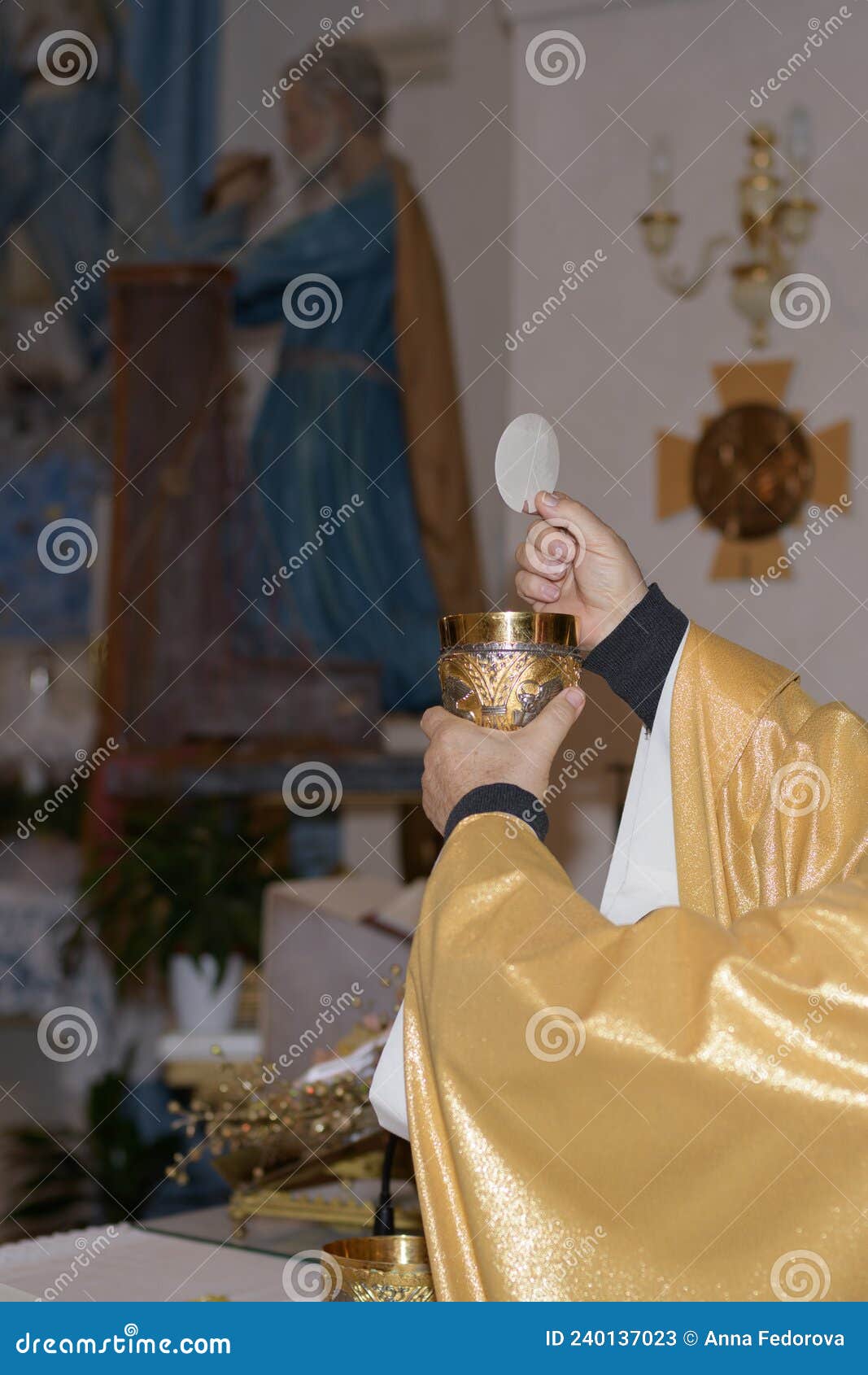 Holy Host in the Hands of the Priest on the Altar during the ...