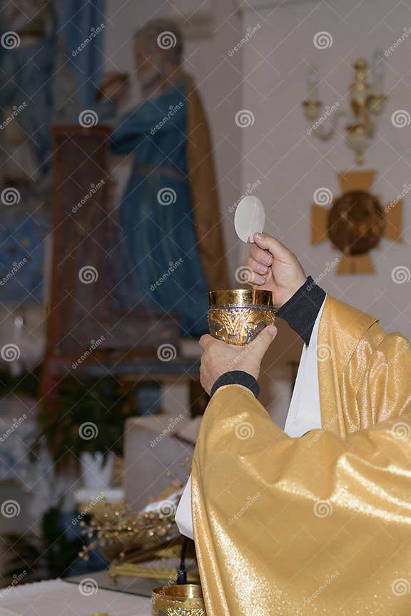 Holy Host in the Hands of the Priest on the Altar during the ...
