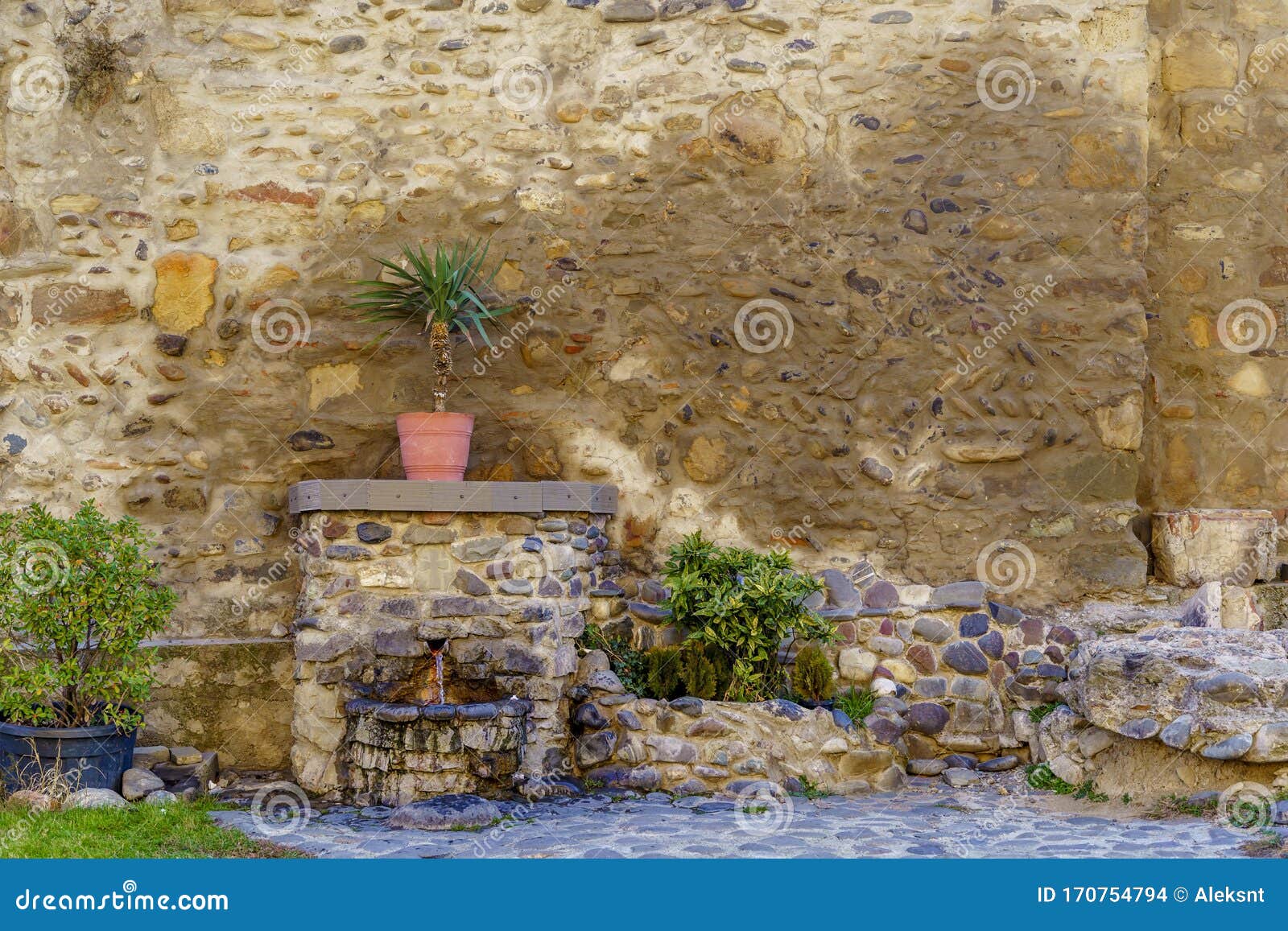 The Holy Spring of Water Flows from the Ancient Monastery Wall Stock ...