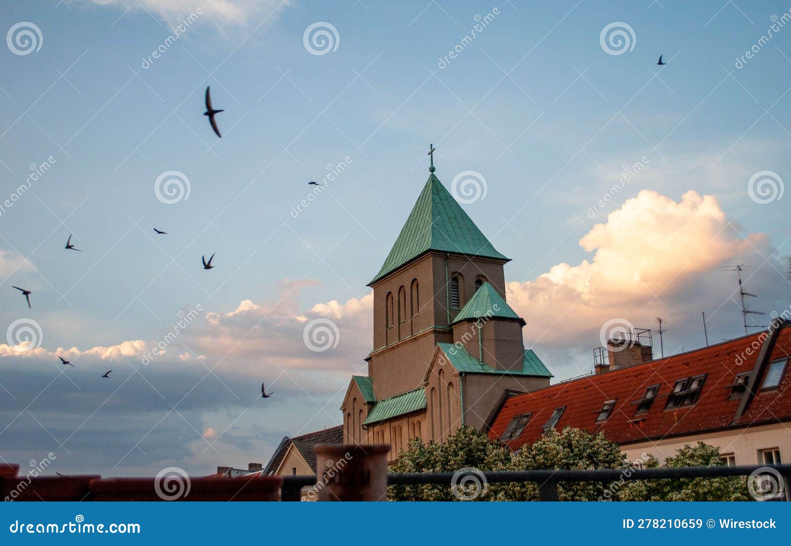 Holy Trinity Catholic Church with Birds Flying in the Blue Sky Stock ...
