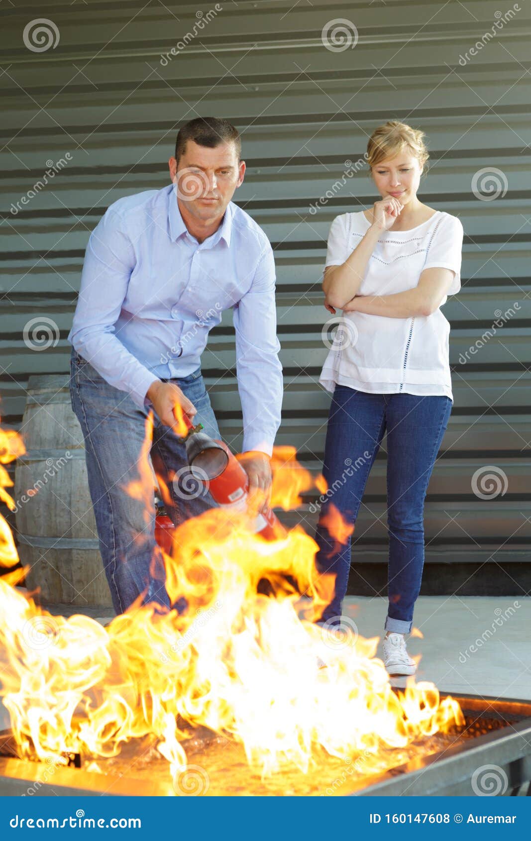 Hombre Apagando Fuego Controlado Con Extintor Foto de archivo - Imagen ...