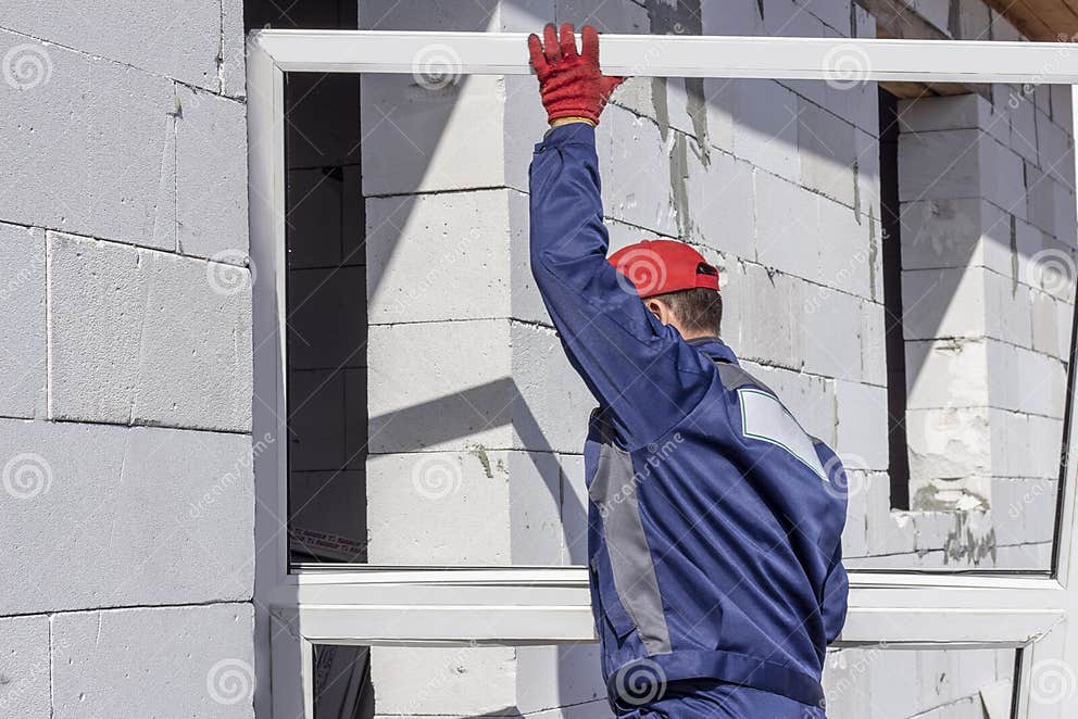 Home Construction Loader Worker Carries a Platic Window for ...