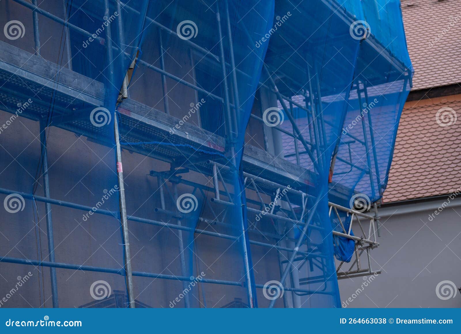 Home Construction. Scaffolding in a Protective Blue Grid. Building Work ...