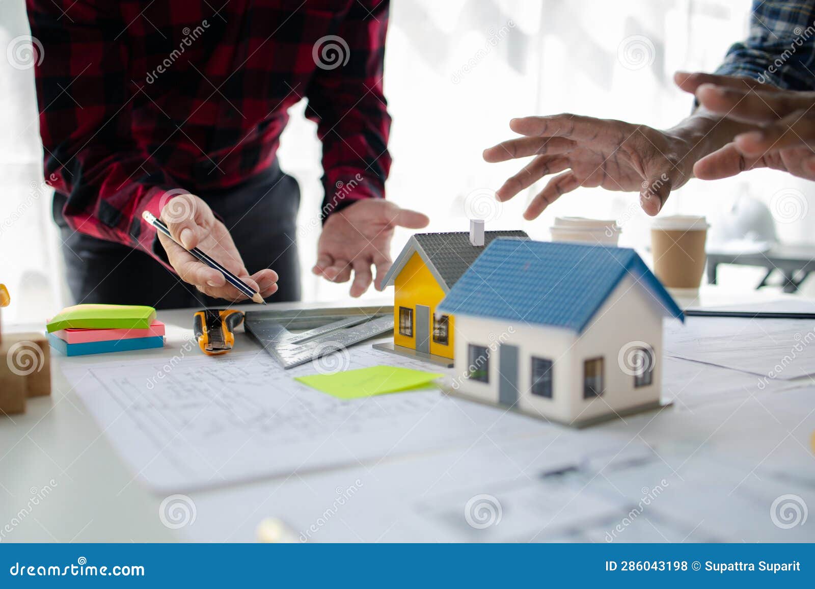 The Home Design Architects are Reviewing the House Plan Draft, the ...