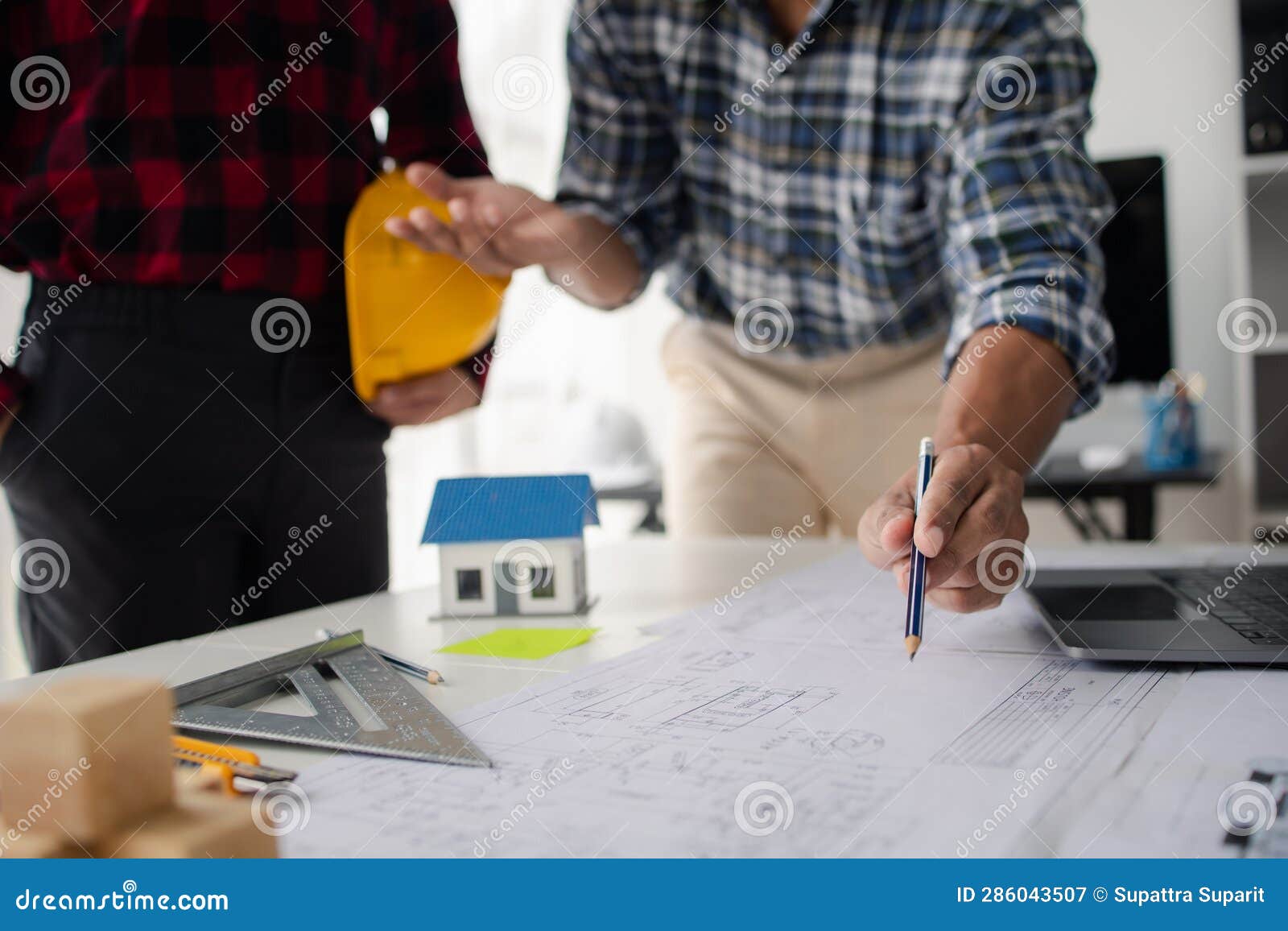 The Home Design Architects are Reviewing the House Plan Draft, the ...