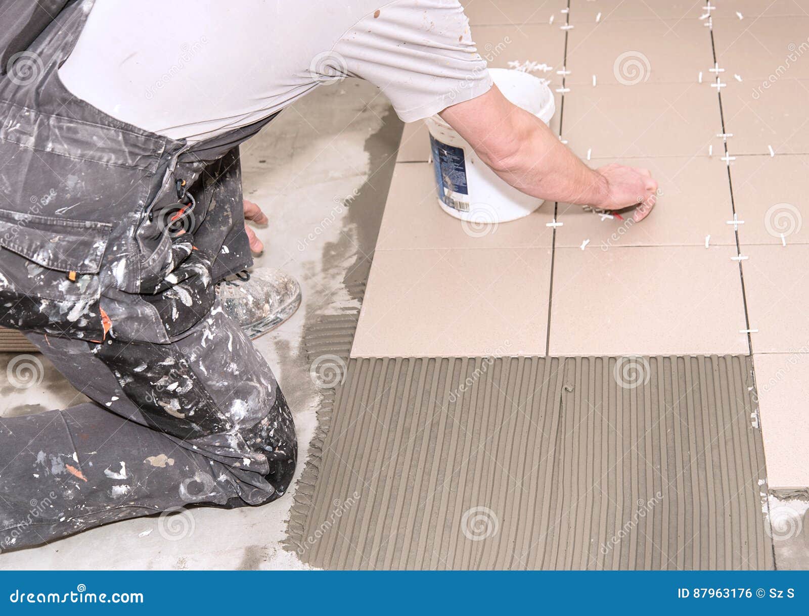 Home Improvement, Renovation. Construction Worker is Tiling, Ceramic ...