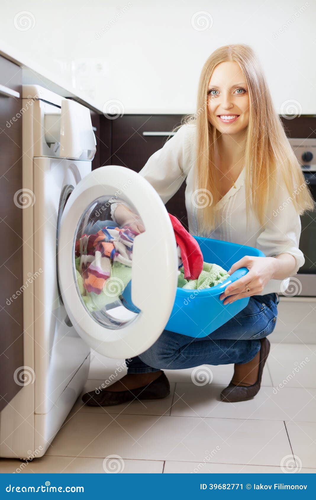 Home Laundry. Happy Woman Loading the Washing Machine Stock Image ...