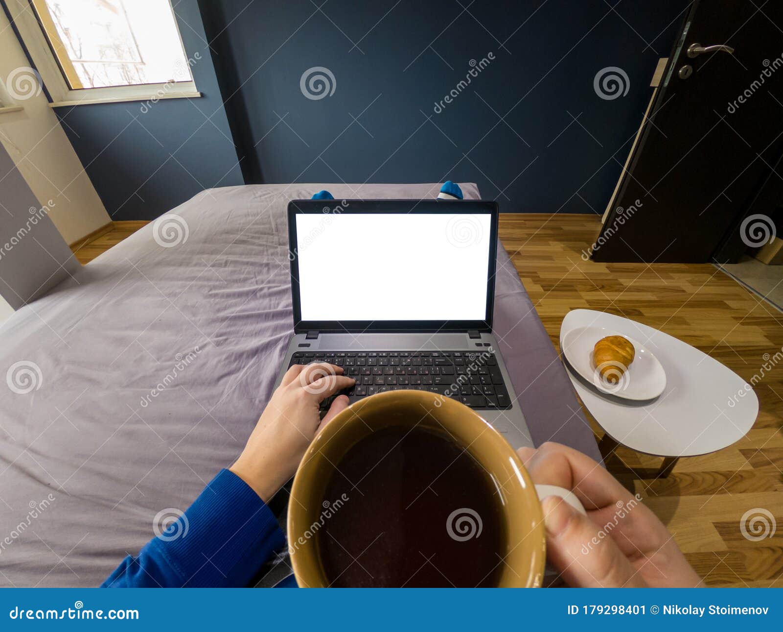 Home Office Concept. Man Drinking Coffee and Working on a Laptop Stock ...
