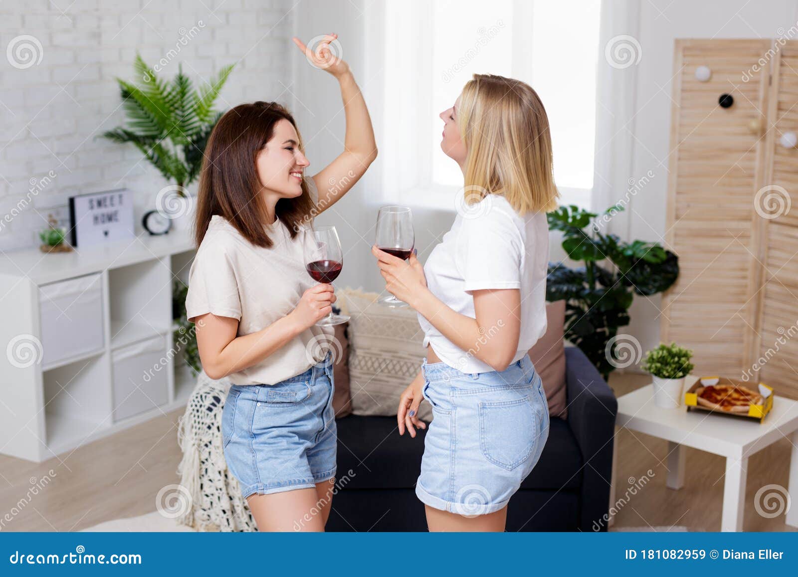 Home Party Two Beautiful Girls Having Fun Together Drinking Wine And