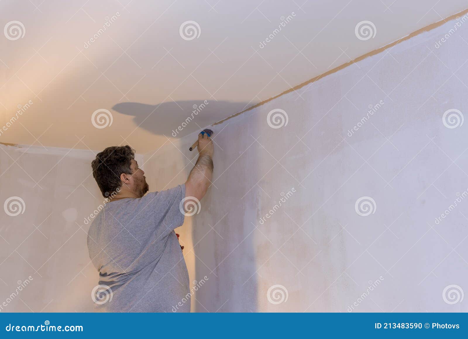 Home Renovation Applying Paint on Wall Using Brush Painter Working ...