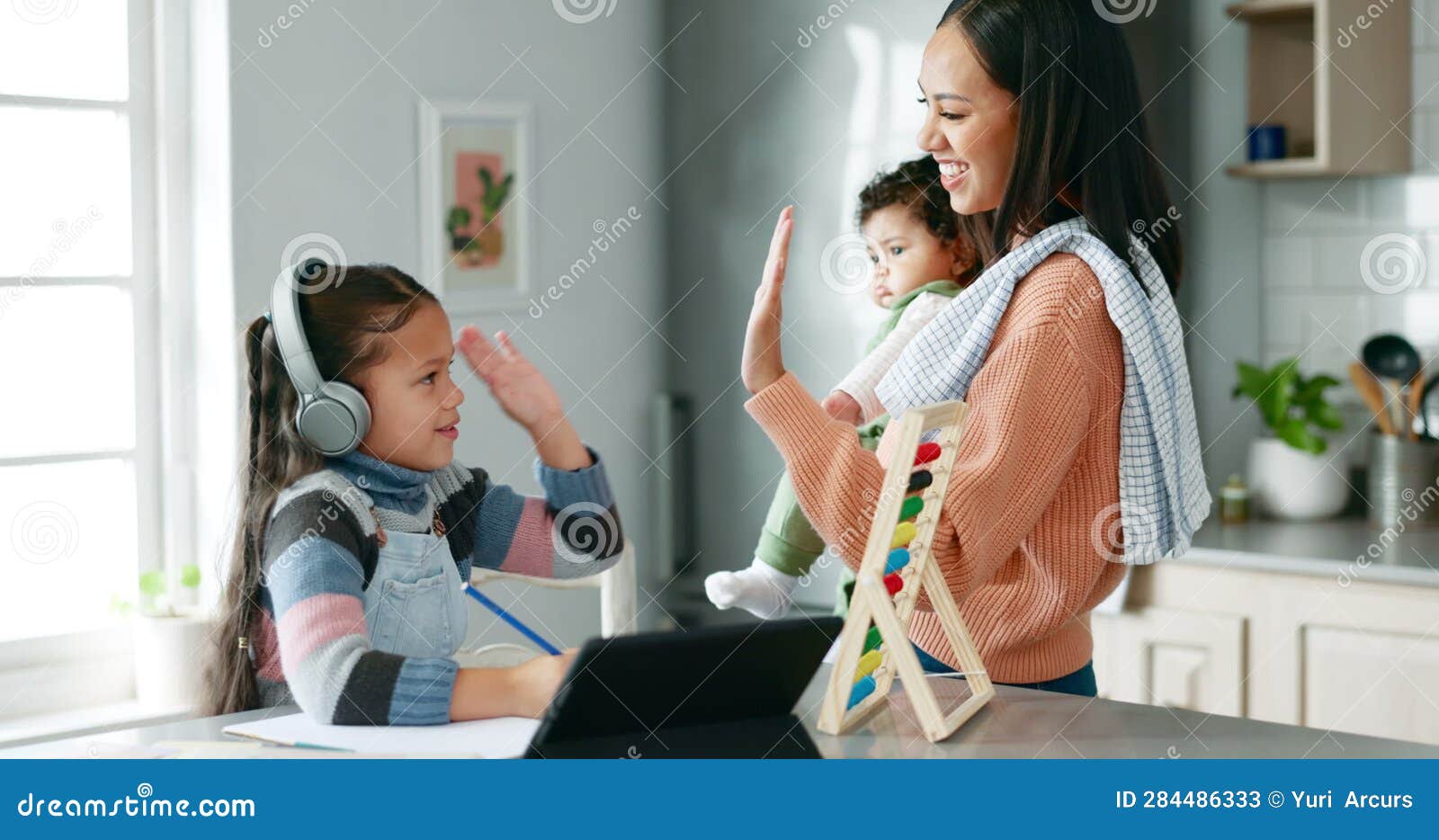 Home School, High Five with Mom and Child in Kitchen with Tablet, Headphones and Success in ...