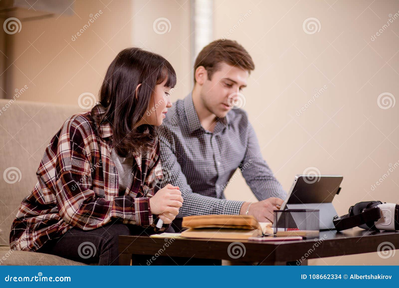 Two Students Working on a Project on Laptop, the Atmosphere is Cozy and ...