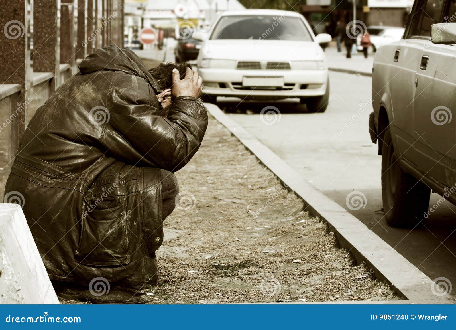 Sad Homeless Man Sitting at the Wall in City Street Stock Photo - Image ...