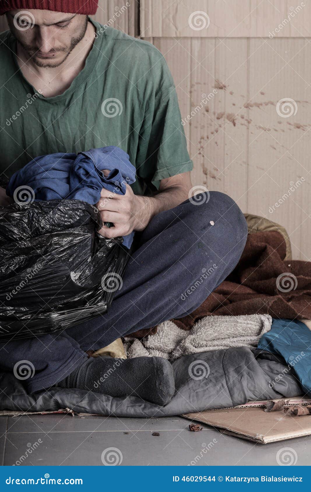 Homeless Man Looks a Bag of Clothes Stock Photo - Image of clothes ...