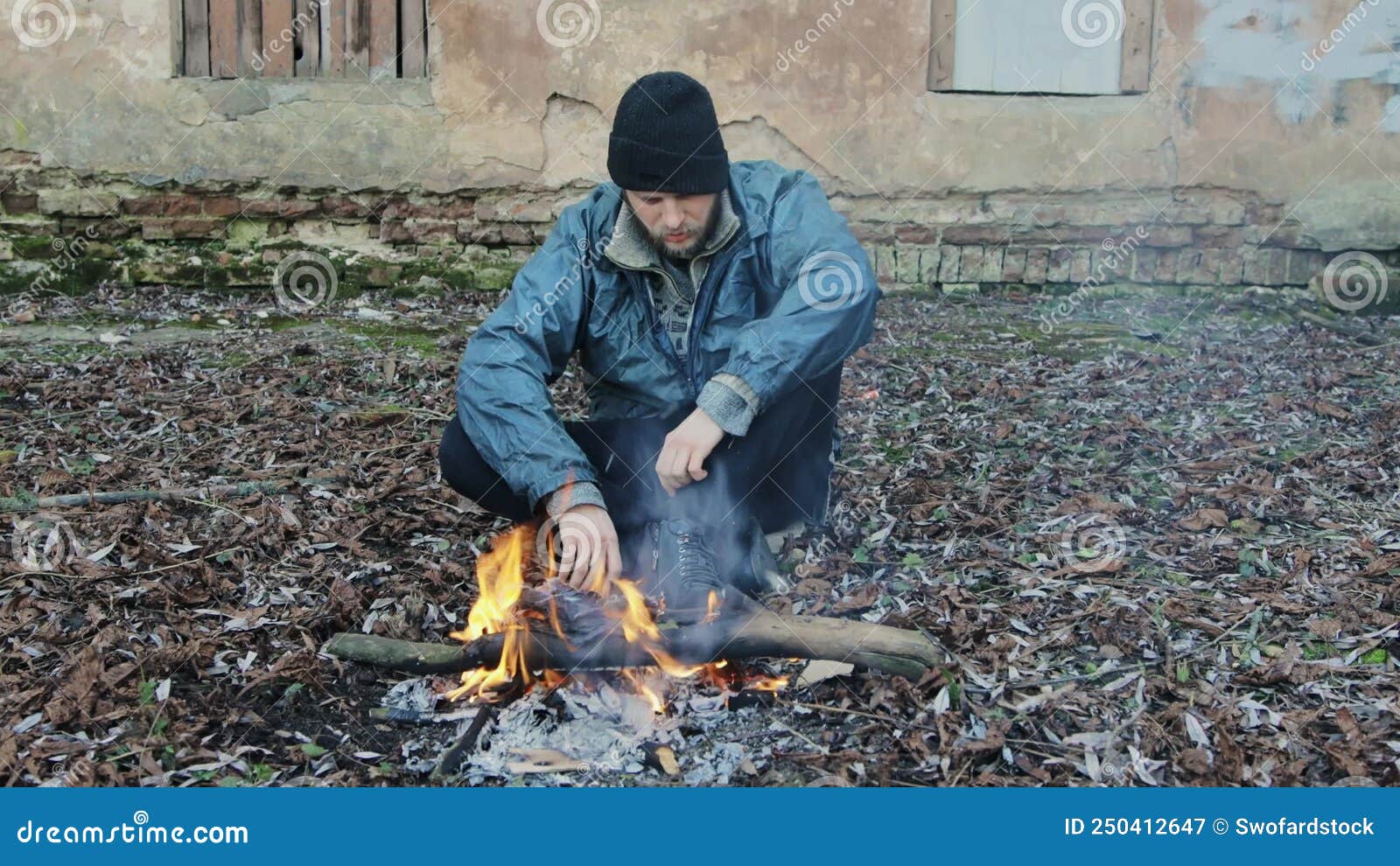 Homeless Man Sitting and Warming Himself by the Fire from Cold. Tramp ...