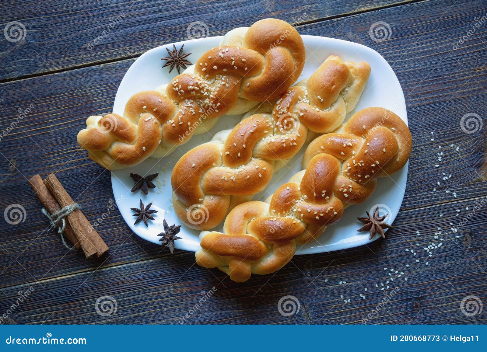 Homemade Braided Pastries with Cinnamon and Sesame Seeds on Rustic ...