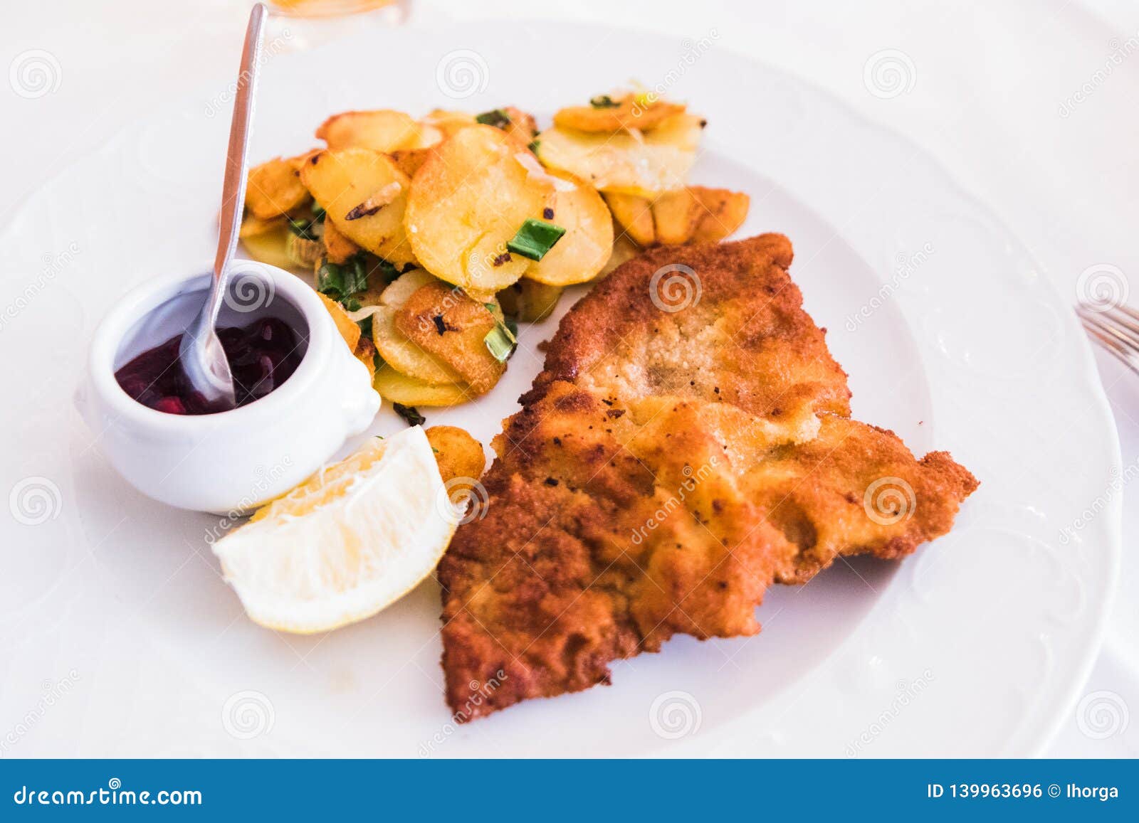 A Homemade Breaded German Weiner Schnitzel with Cooked Potatoes Stock ...