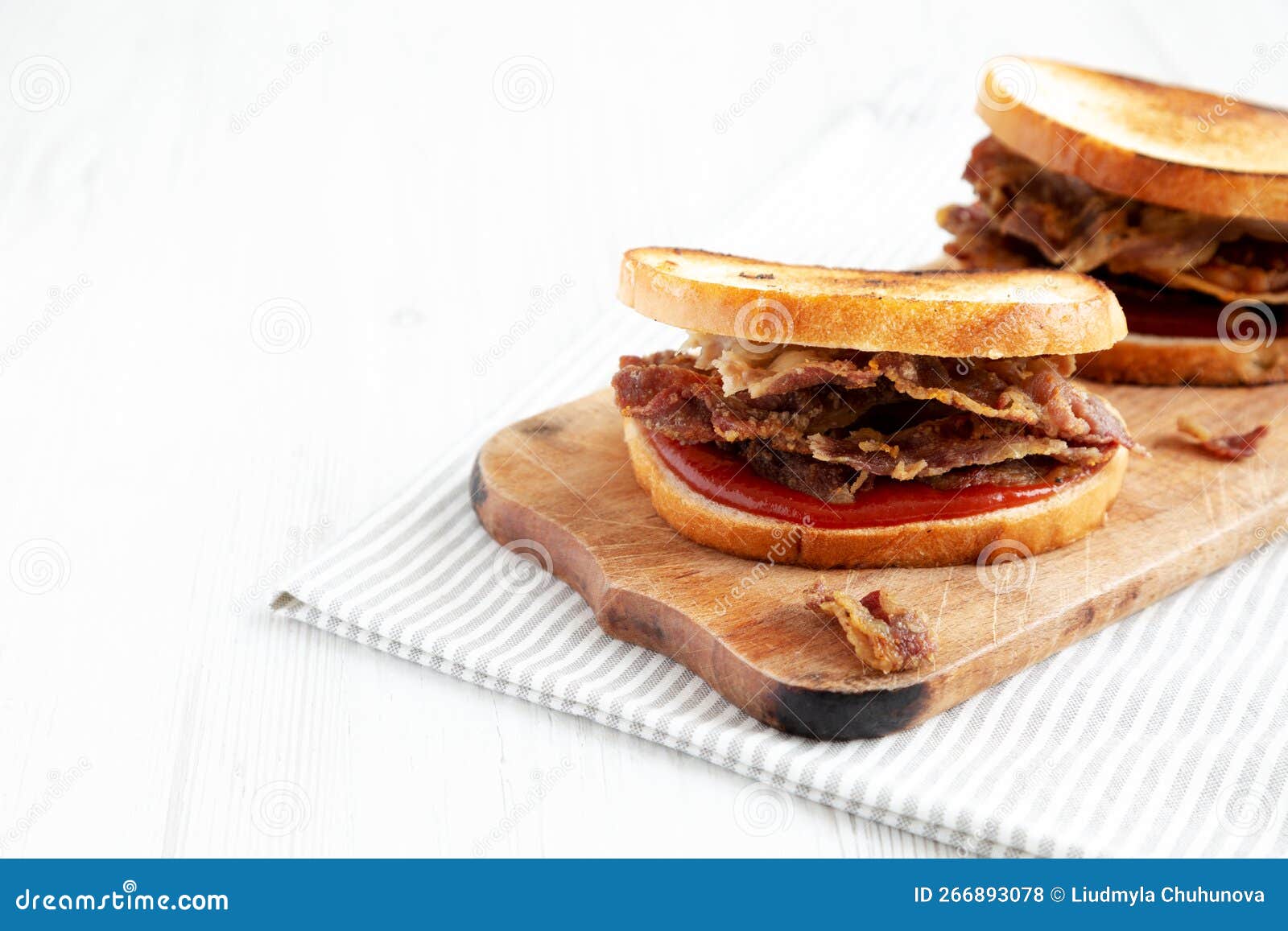 Homemade British Bacon Sandwich on a Rustic Wooden Board, Side View ...
