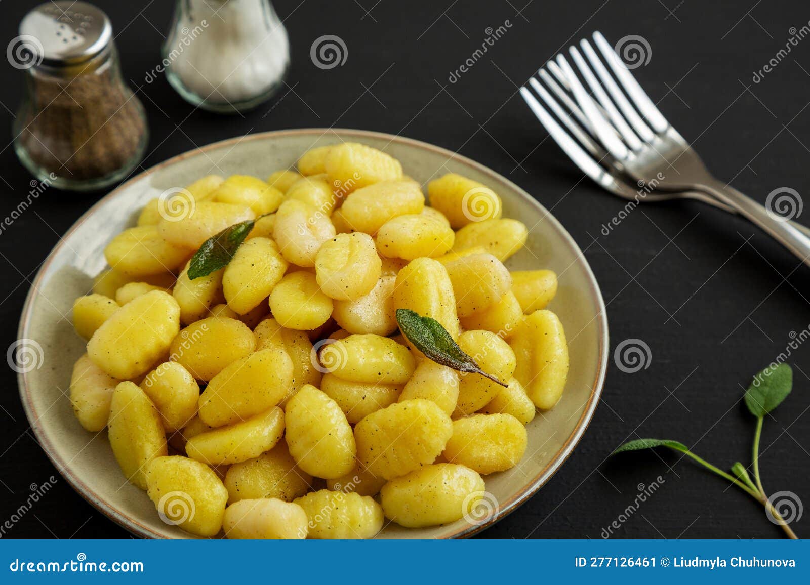 Homemade Easy Potato Gnocchi on a Plate on a Black Background, Side ...