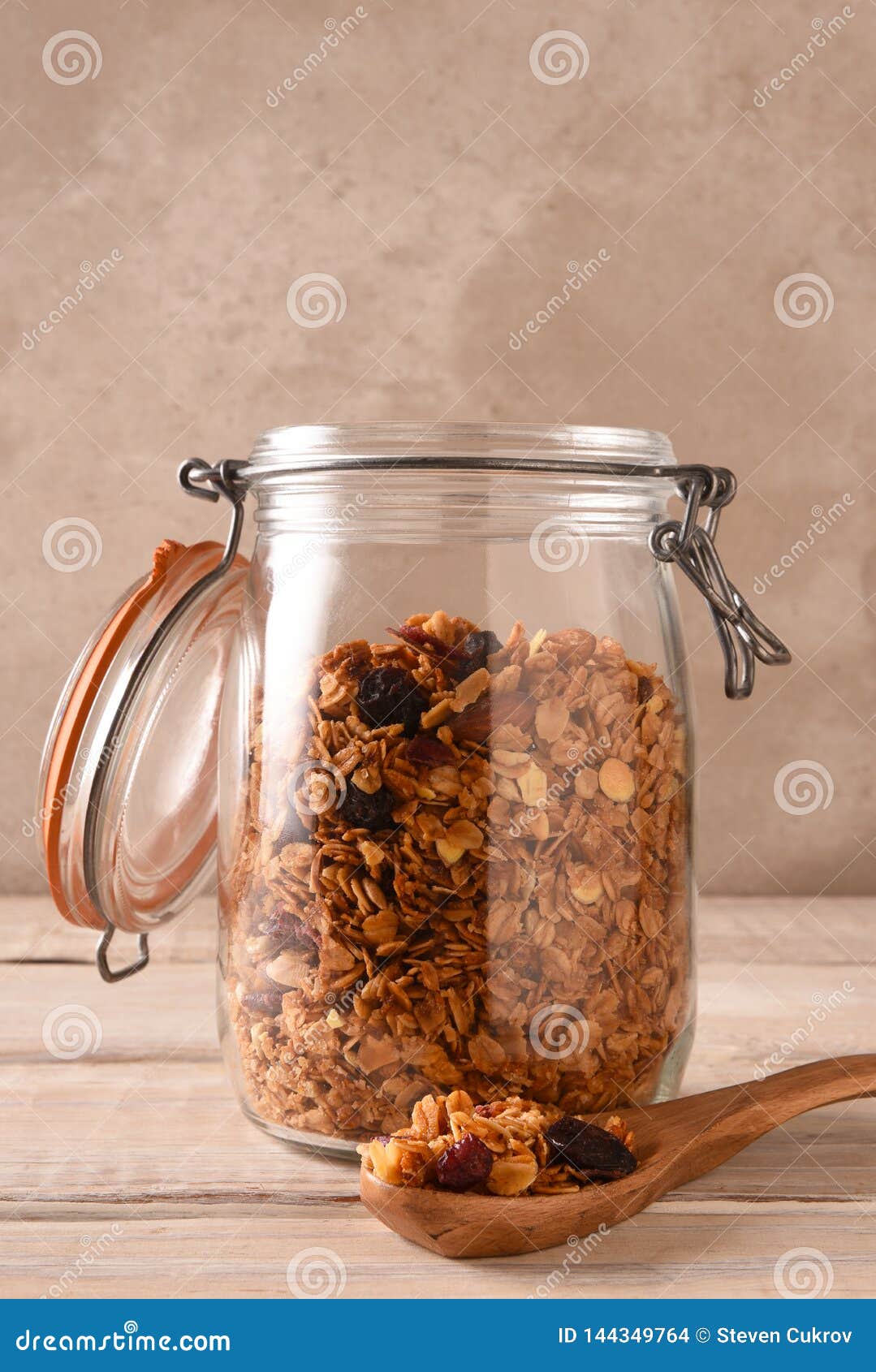 Homemade Granola in a Storage Jar with Teh Lid Open a Spoonful in the ...