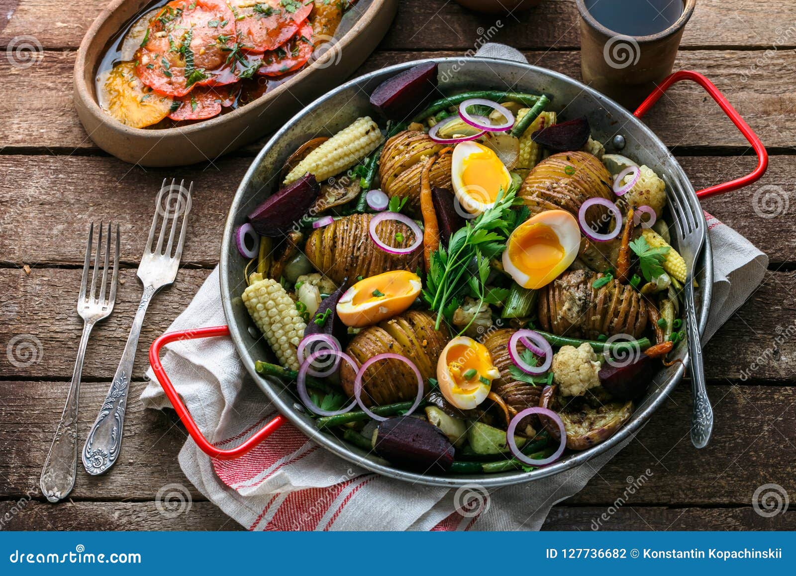 Homemade Hasselback Potatoes in a Pat with Root Vegetables. Stock Photo ...