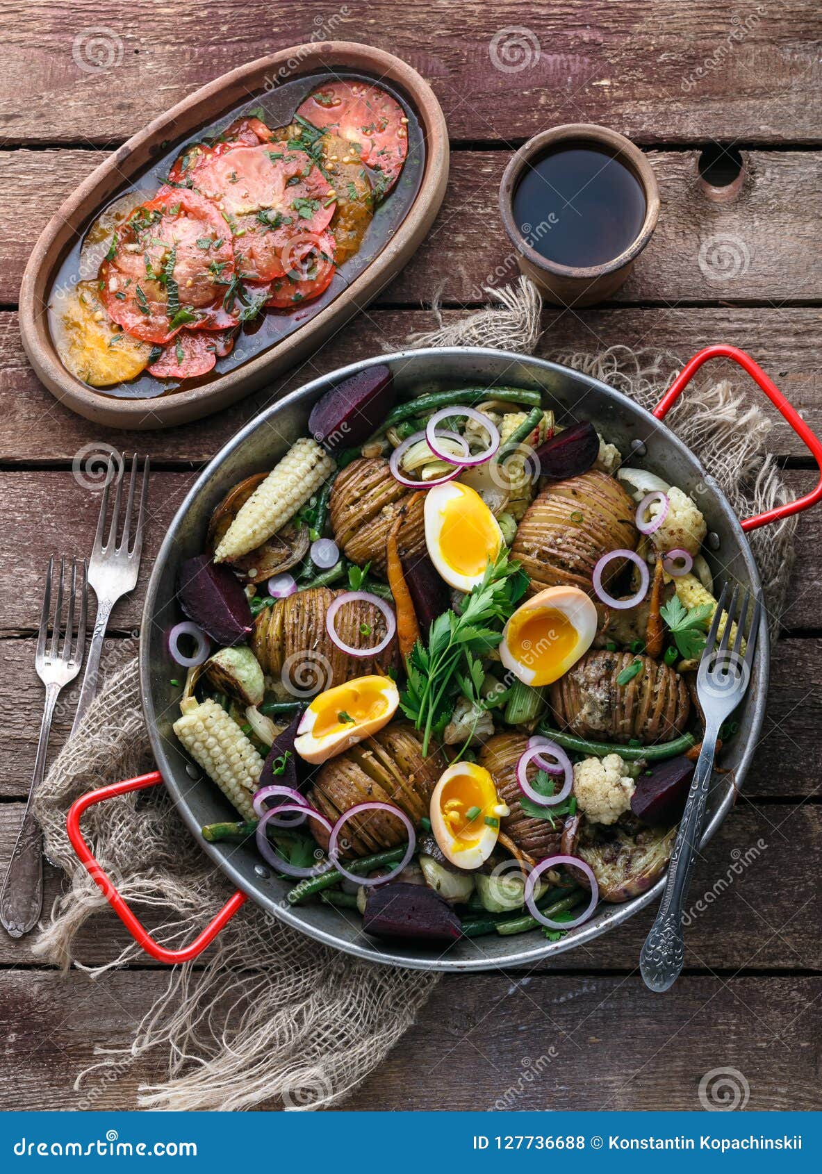Homemade Hasselback Potatoes in a Pat with Root Vegetables. Stock Photo ...