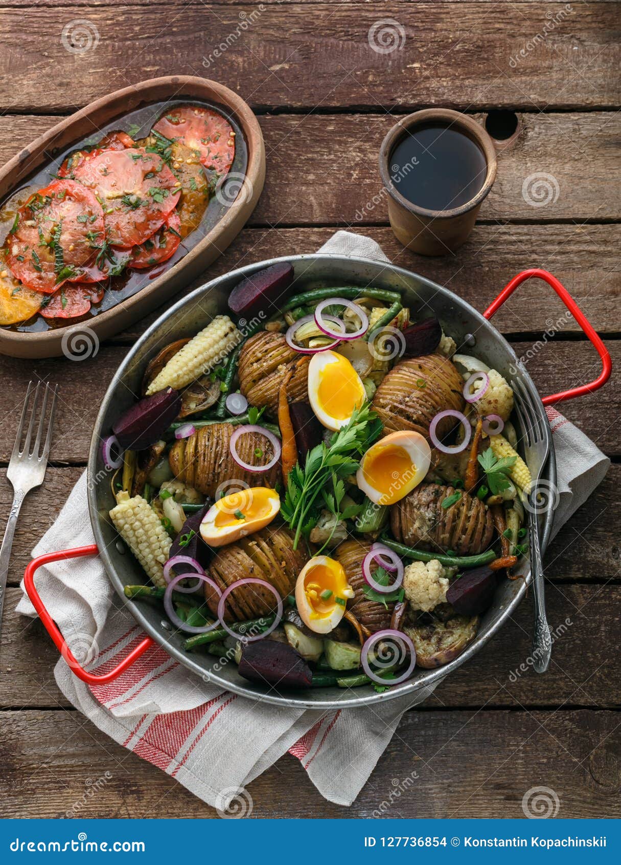 Homemade Hasselback Potatoes in a Pat with Root Vegetables. Stock Photo ...