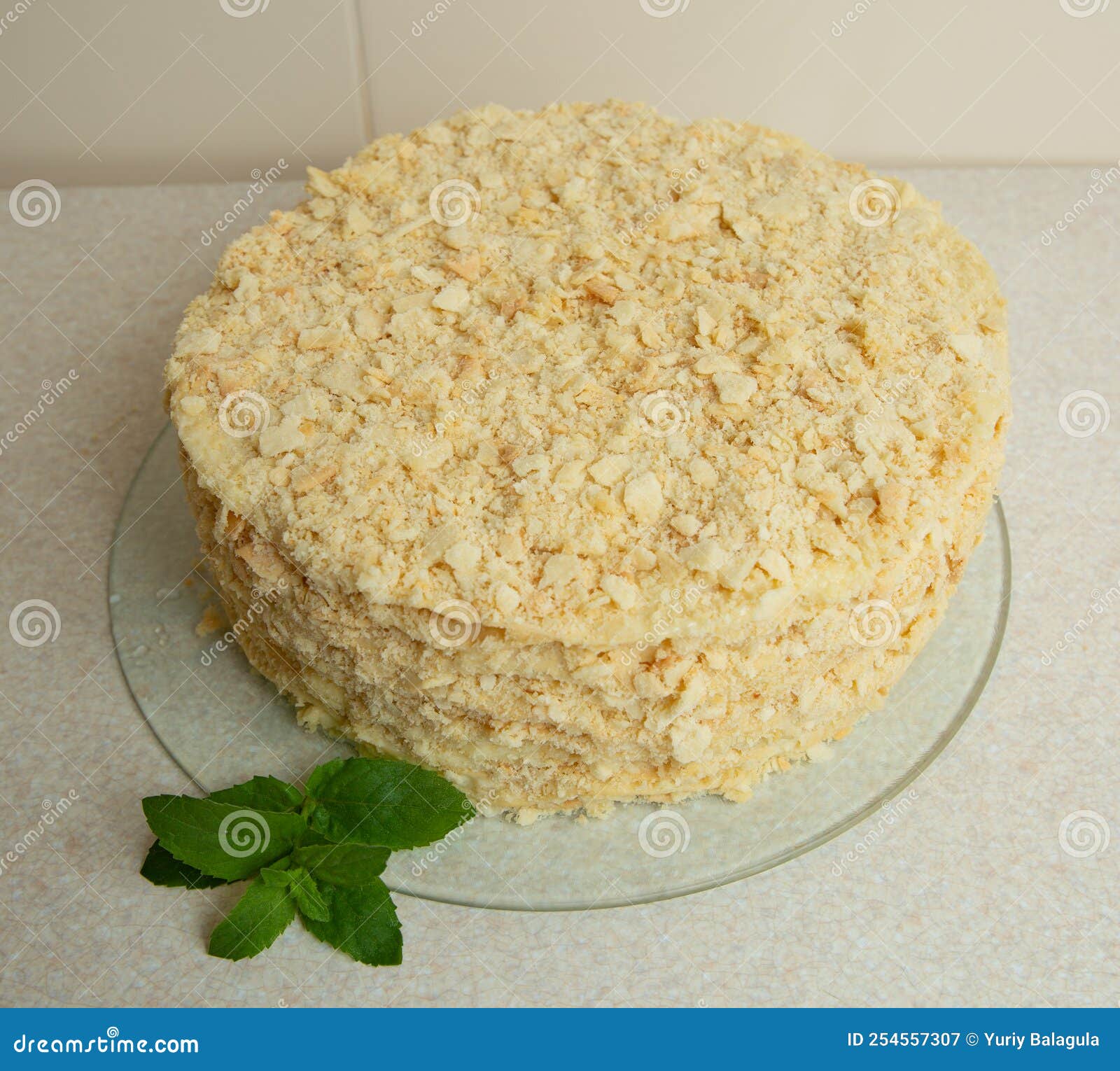 Homemade Napoleon Cake Stands on the Table in the Kitchen. it is ...