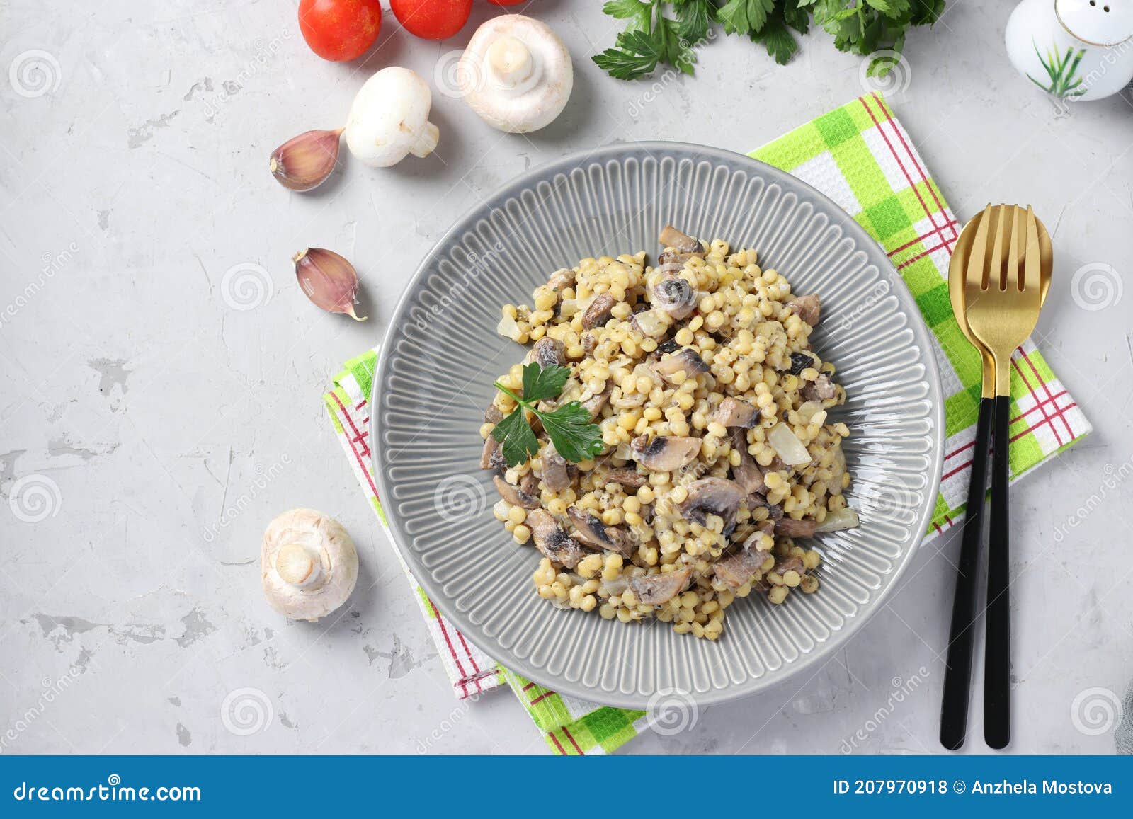 Homemade Ptitim Pasta with Champignons in a Plate on Light Gray Table ...