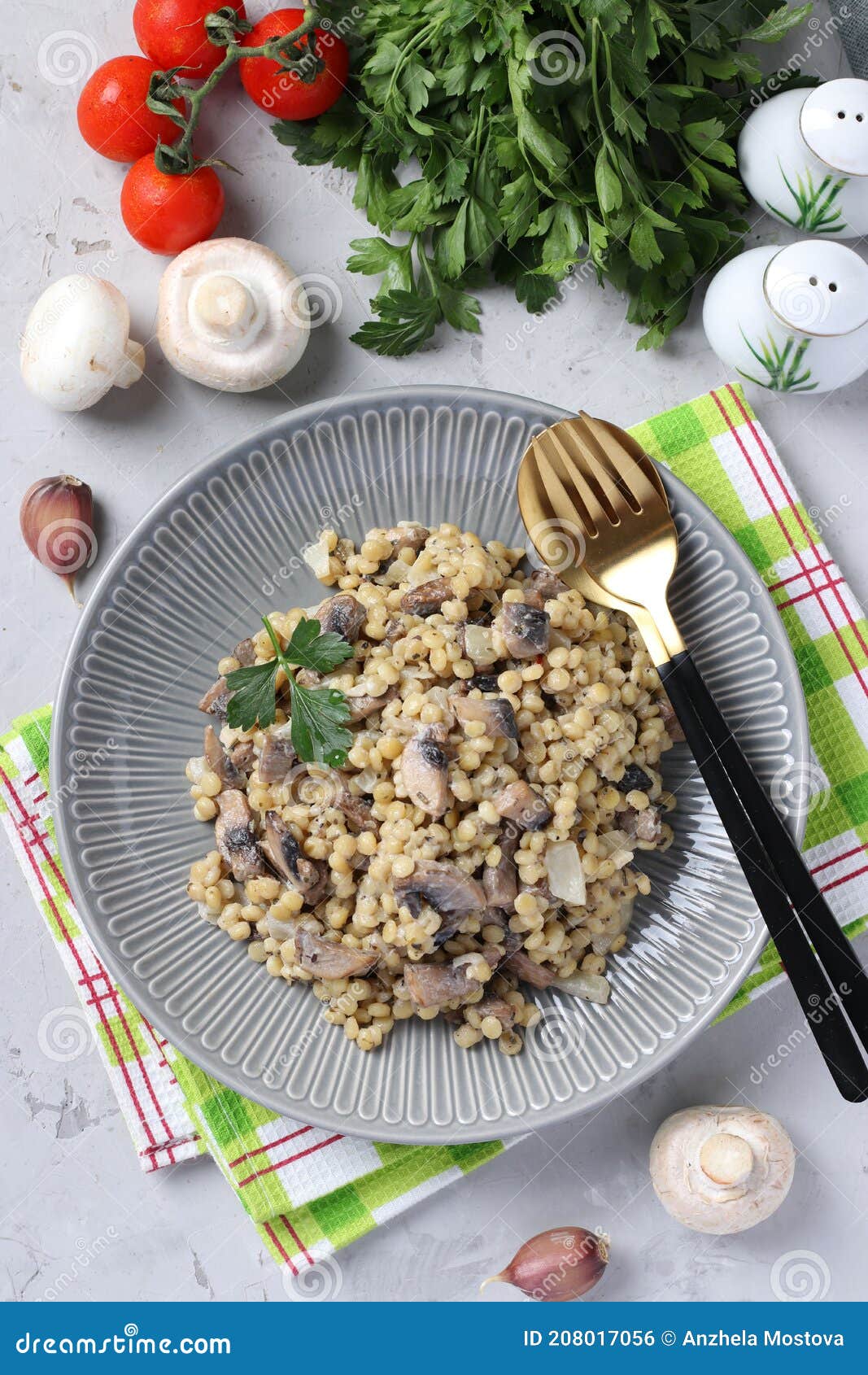 Homemade Ptitim Pasta with Champignons in a Plate on Light Gray Table ...