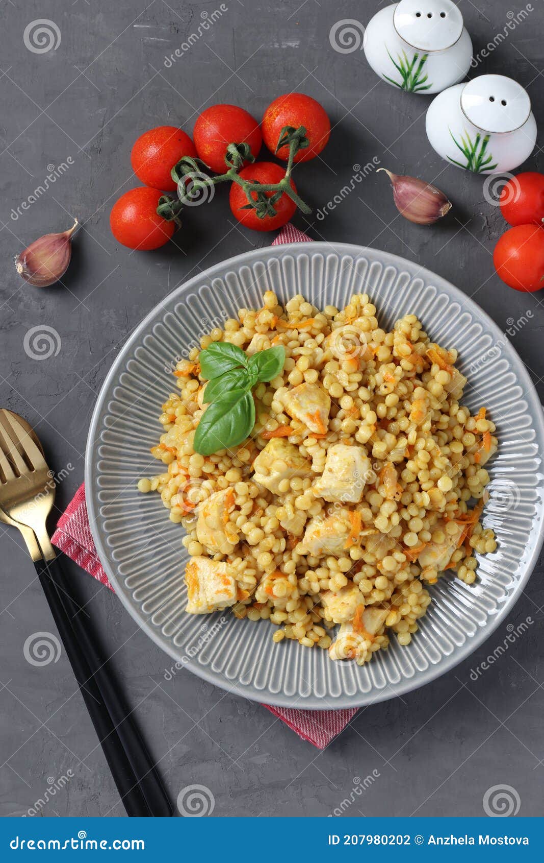 Homemade Ptitim Pasta with Chicken and Vegetables on Dark Gray Table ...