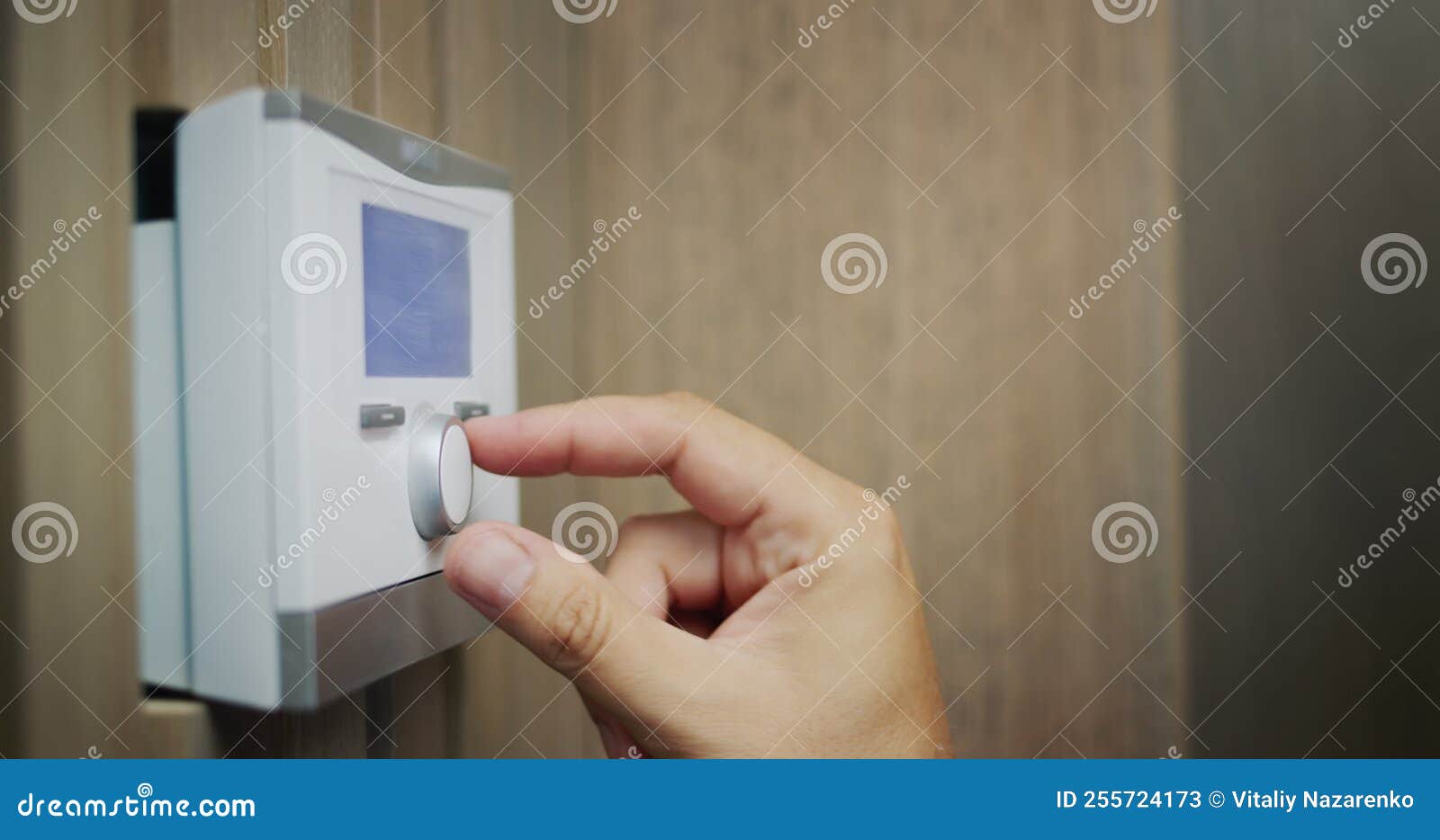 The Homeowner Regulates the Temperature in the House on the Electronic ...