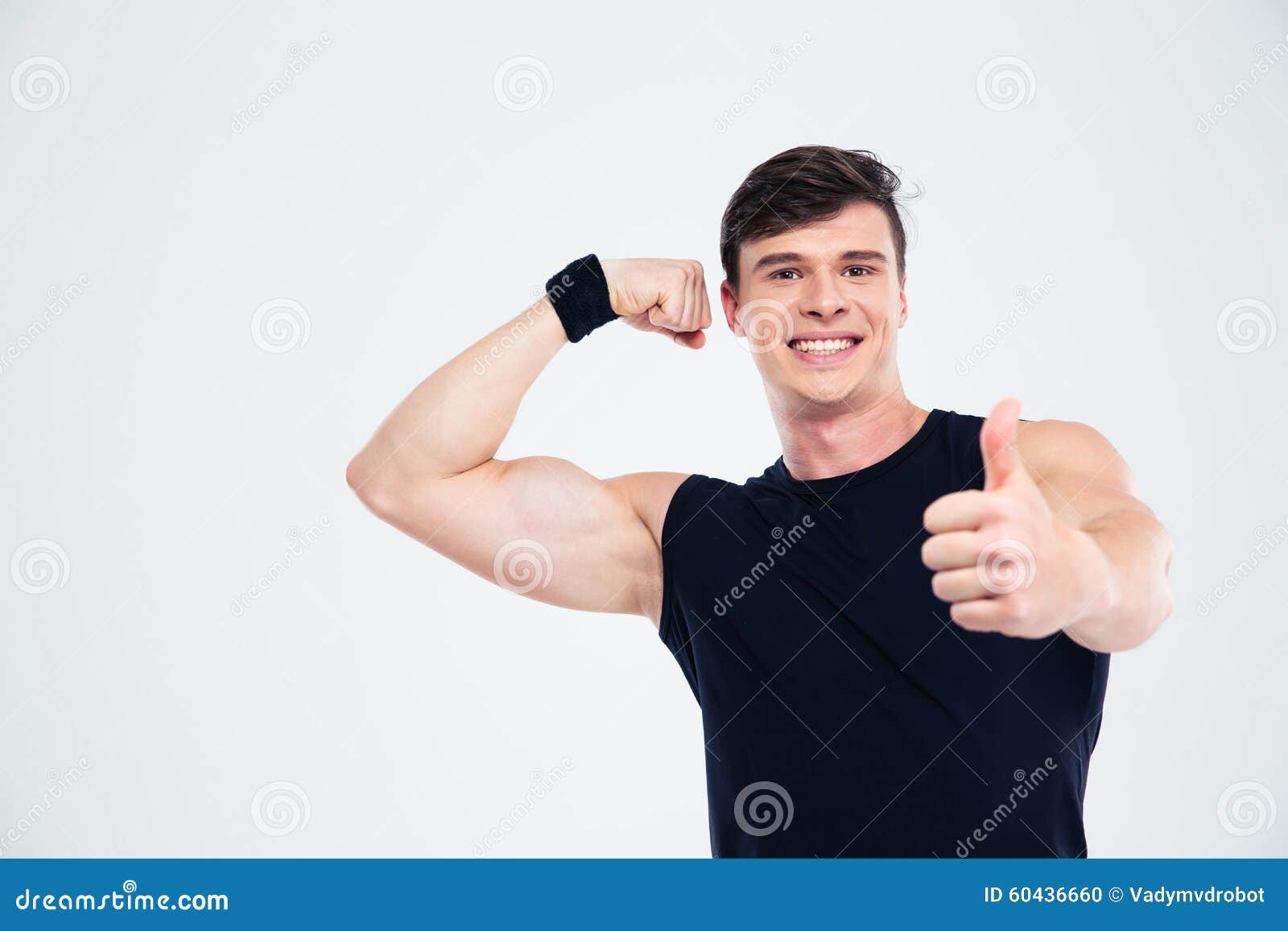 Homme De Forme Physique Montrant Son Biceps Et Pouce Photo Stock