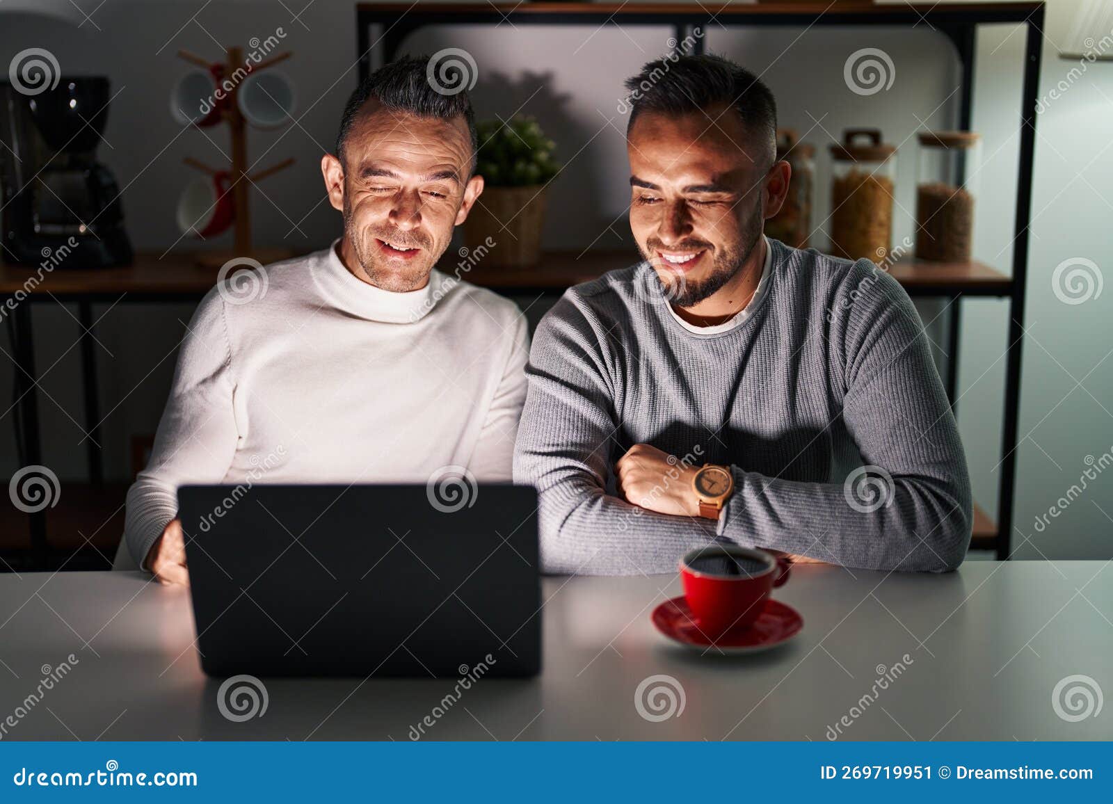 Homosexual Couple Using Computer Laptop Winking Looking at the Camera ...