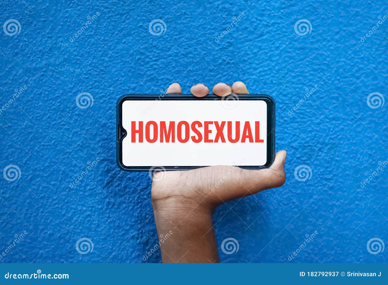Homosexual Word On Smart Phone Screen Isolated On Blue Background With Copy Space For Text